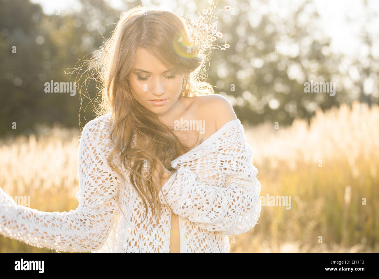Beautiful lady model in open field at sunrise Stock Photo - Alamy
