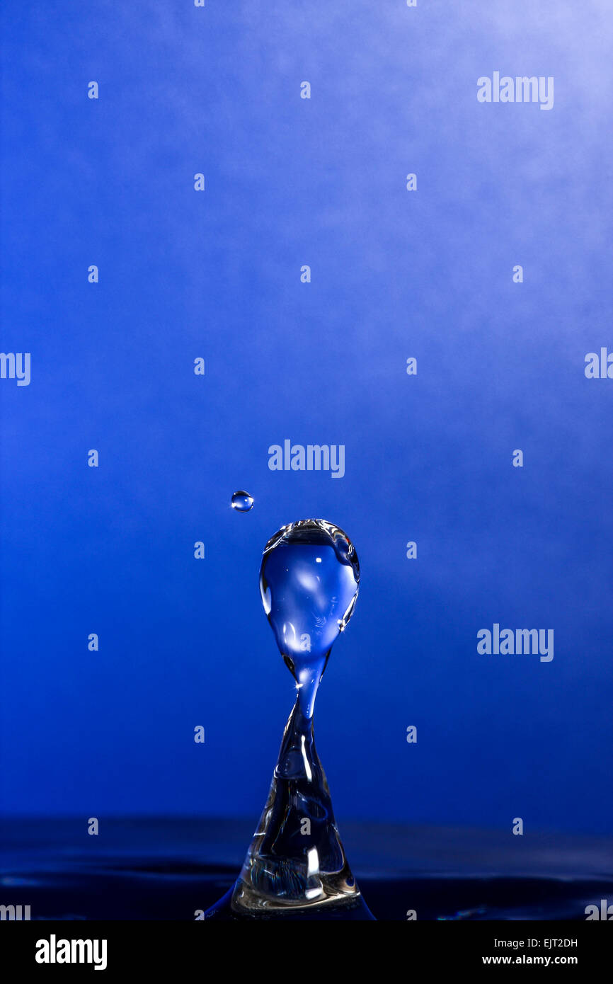 Water drop collisions with a blue background Stock Photo - Alamy