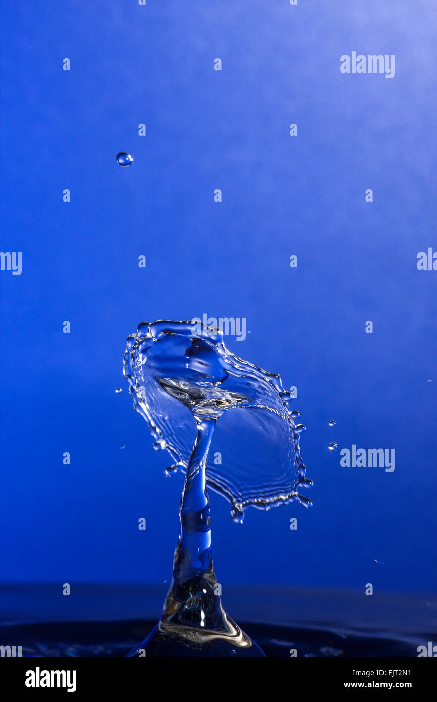 Water drop collisions with a blue background Stock Photo - Alamy