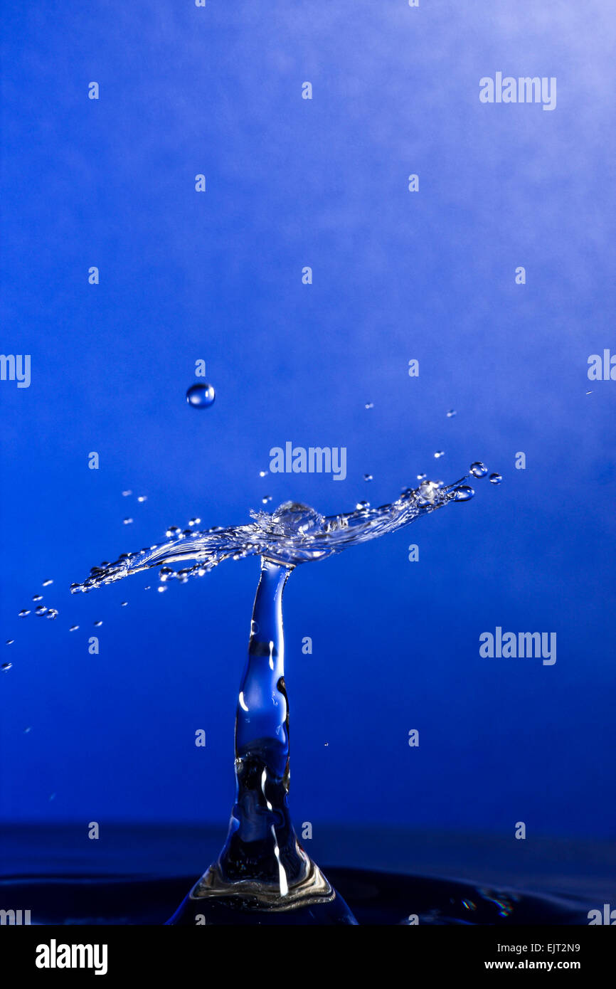 Water drop collisions with a blue background Stock Photo - Alamy