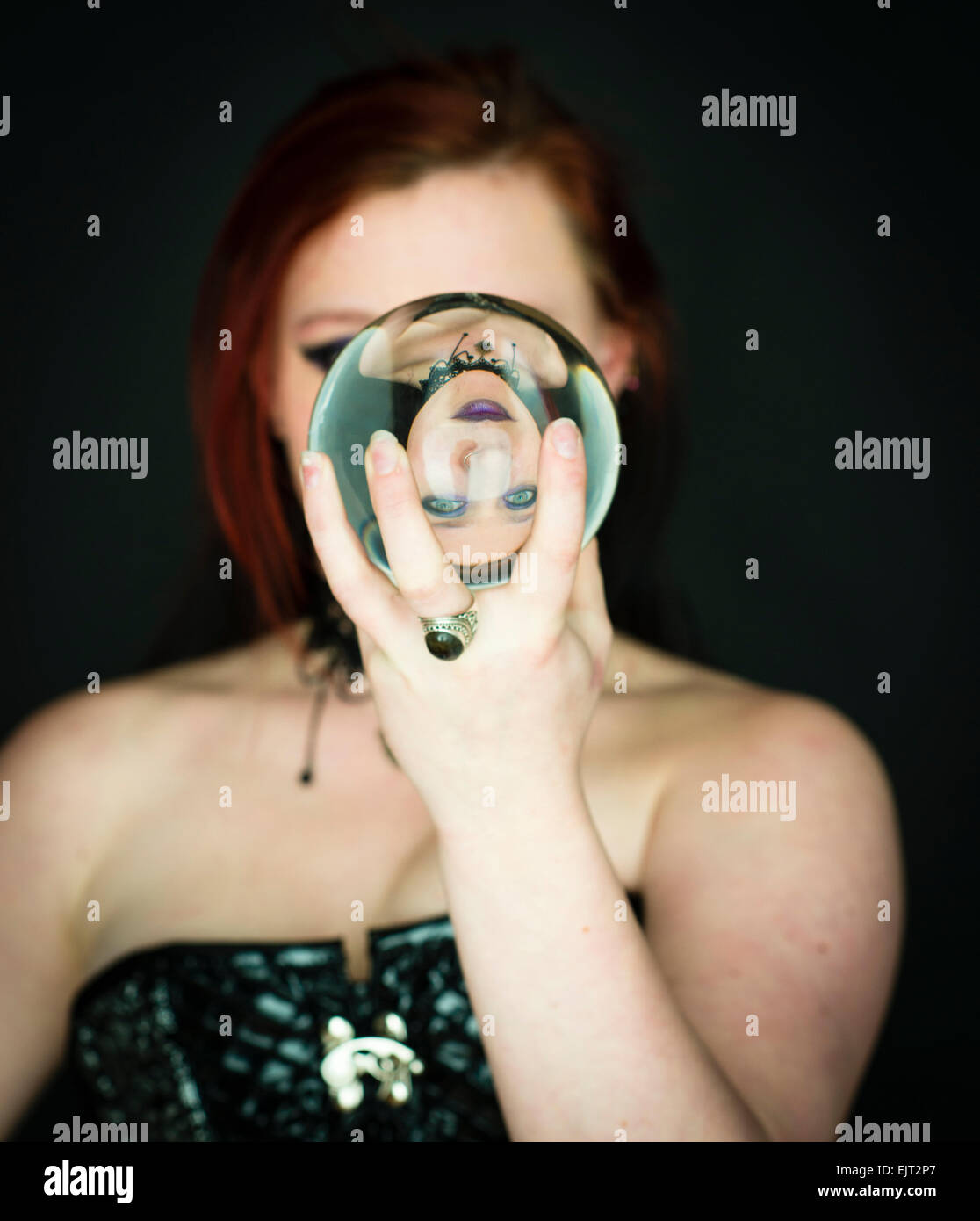 Fortune teller: A young 'goth' woman girl model posing holding a ...