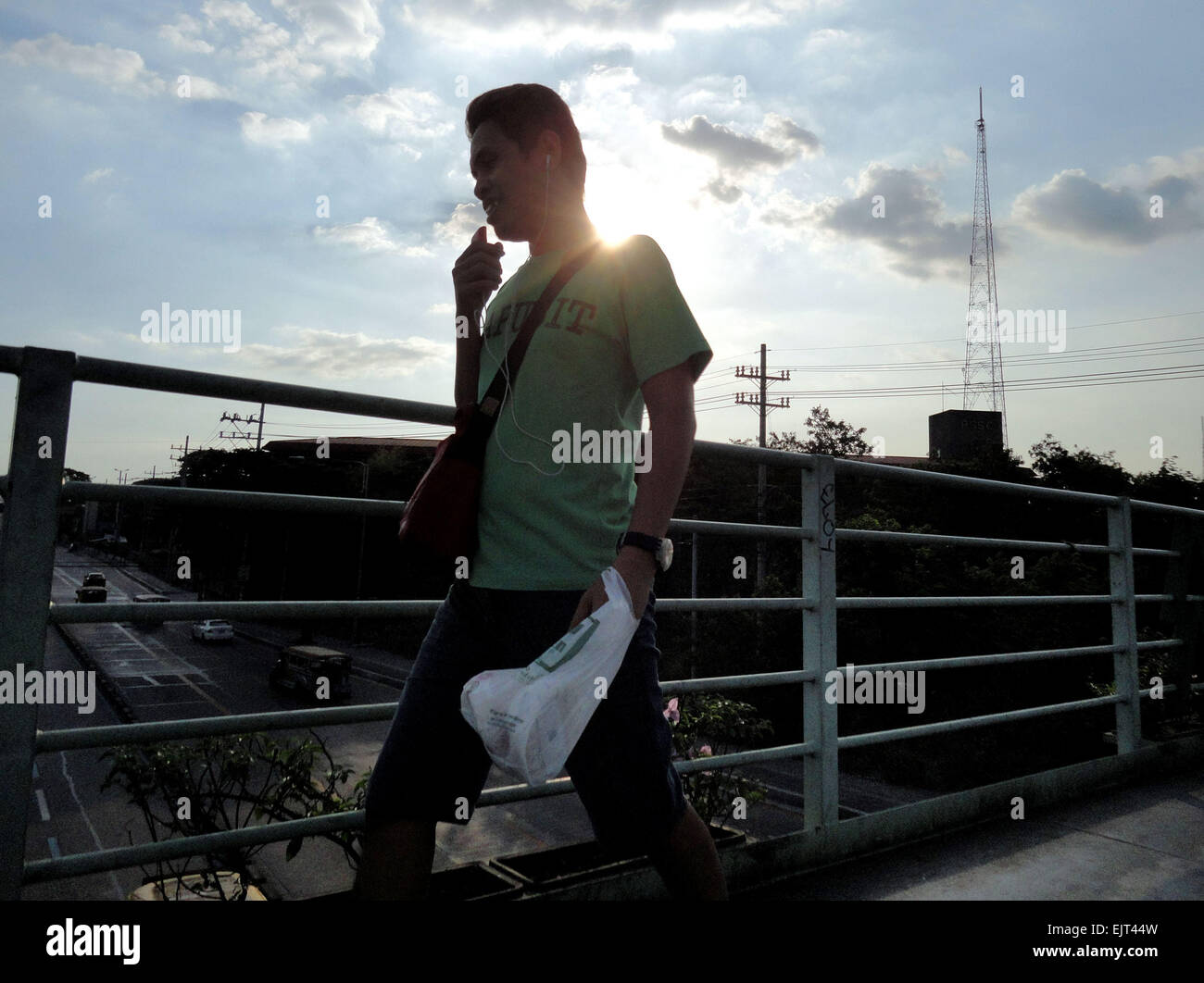Quezon City, Philippines. 31st Mar, 2015. A Filipino man talks on his ...