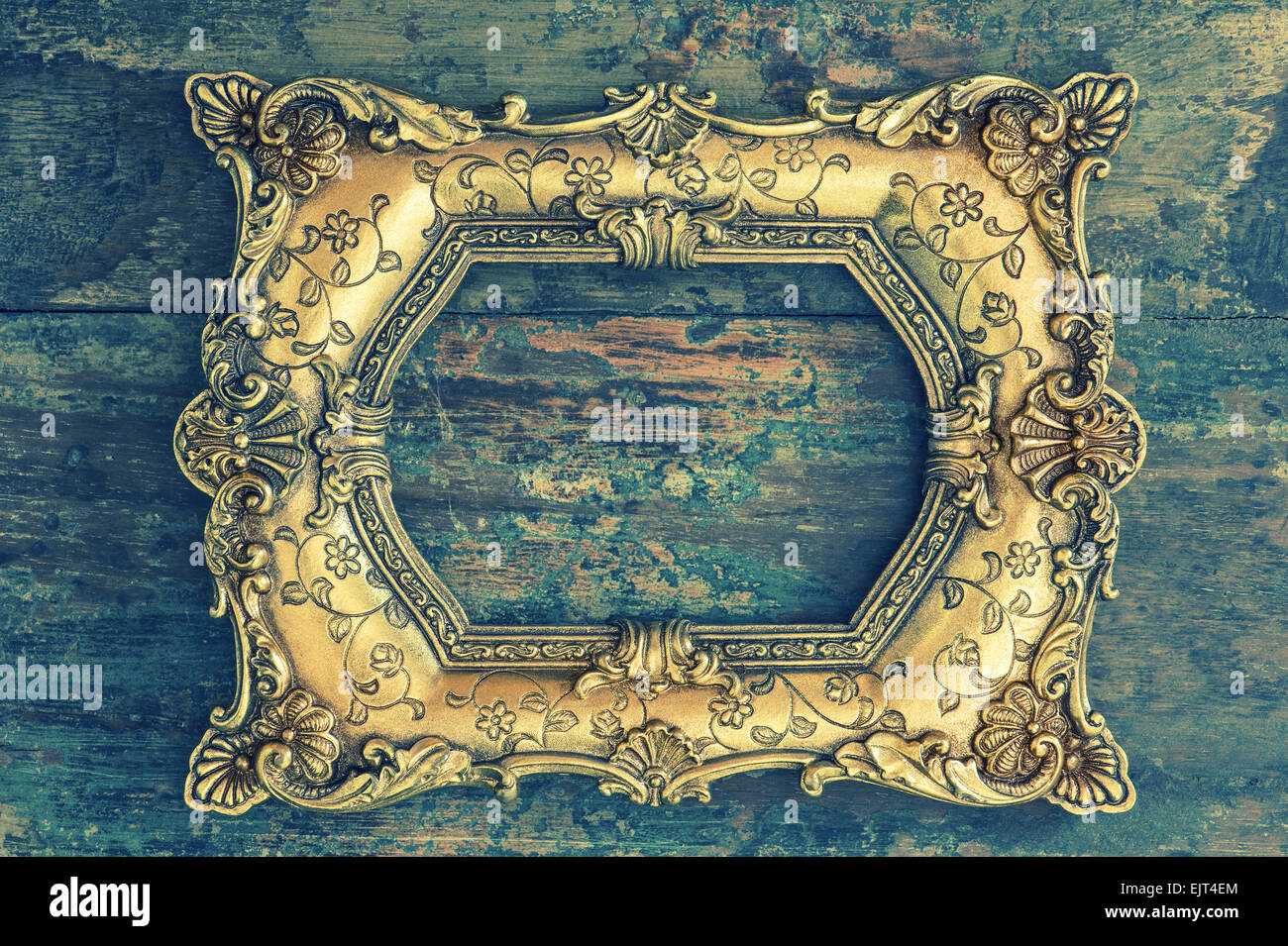 Vintage baroque golden frame on wooden background. Grunge wood texture ...