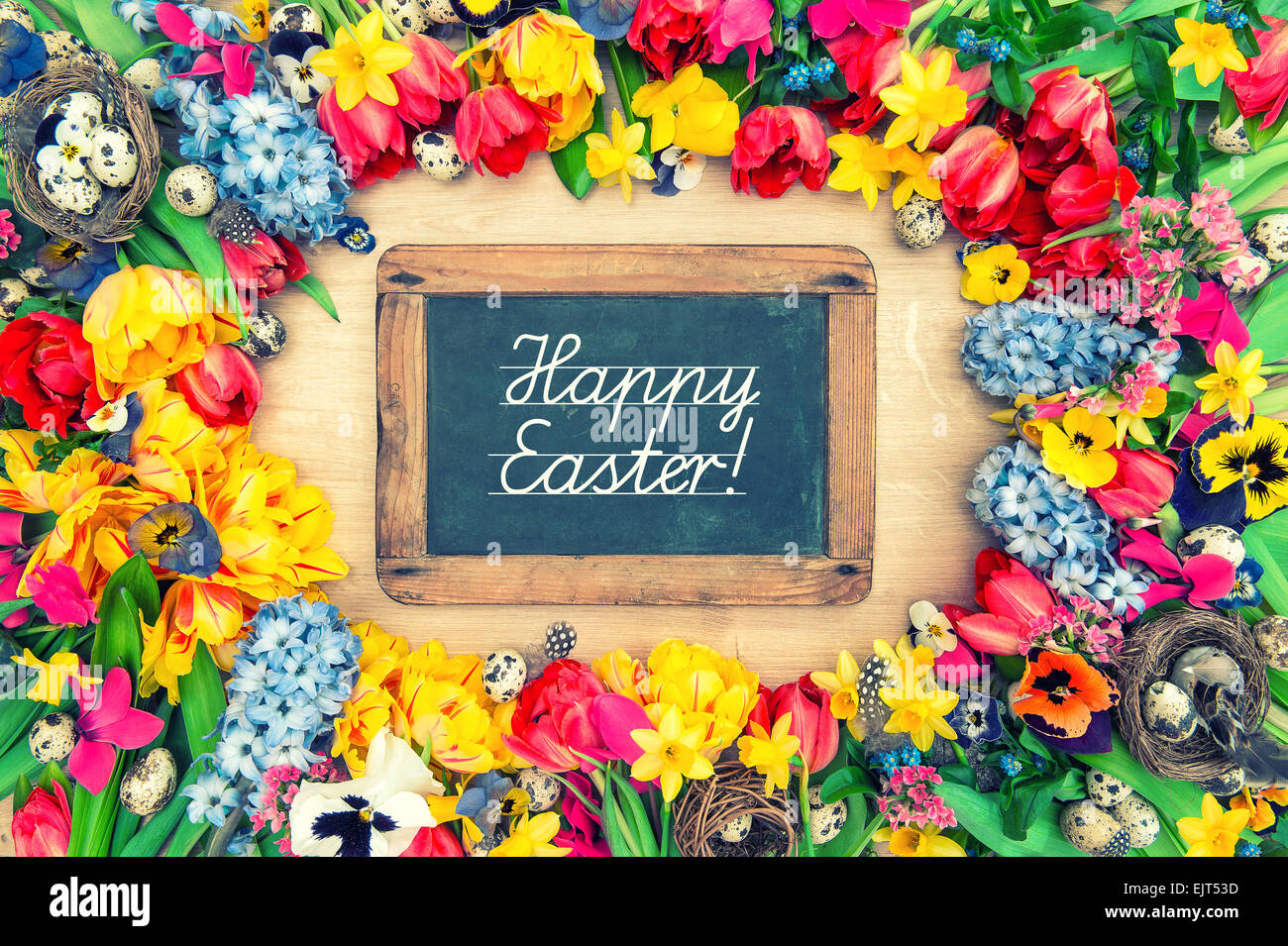 Spring flowers and easter eggs. Tulips, narcissus, hyacinth and pansy ...