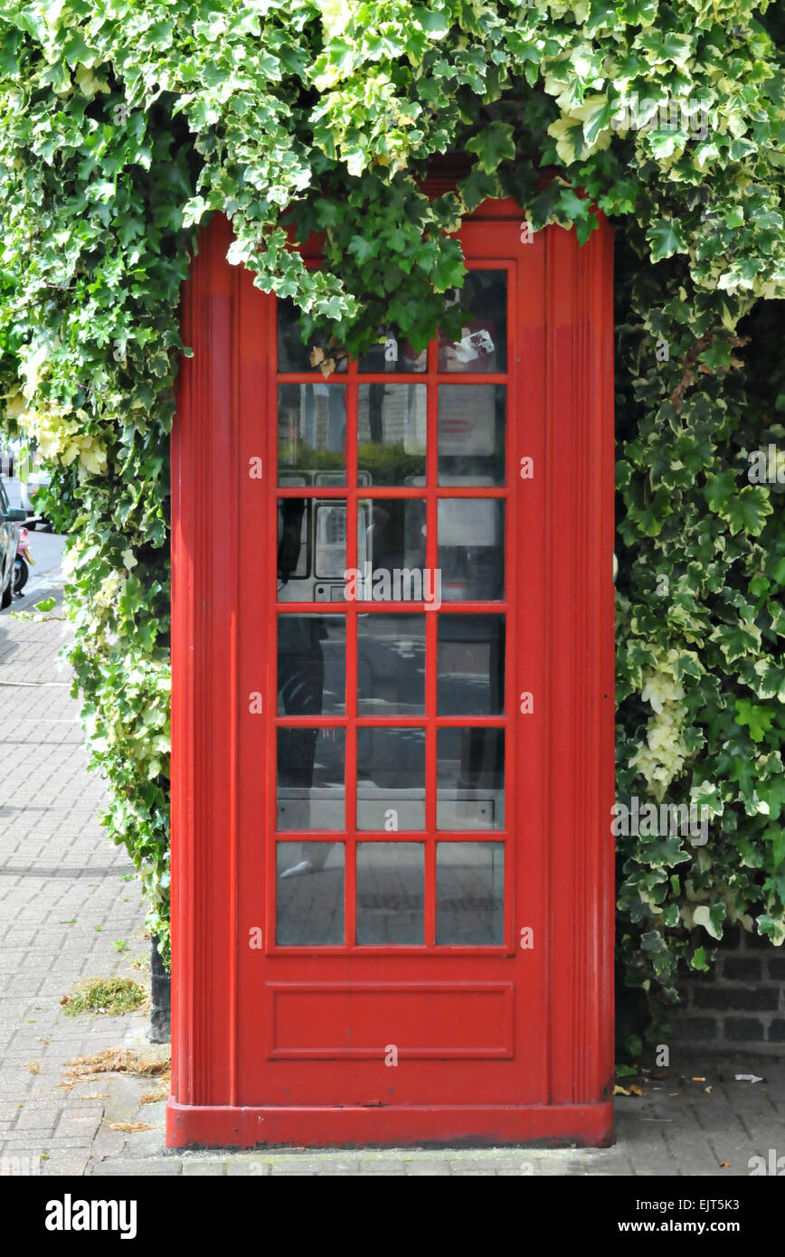 Red telephone box overgrown plants hi-res stock photography and images ...