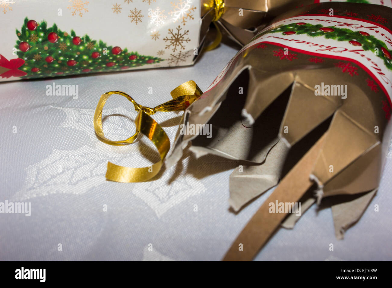 Pulled Christmas cracker after a Christmas meal on a table with a white ...