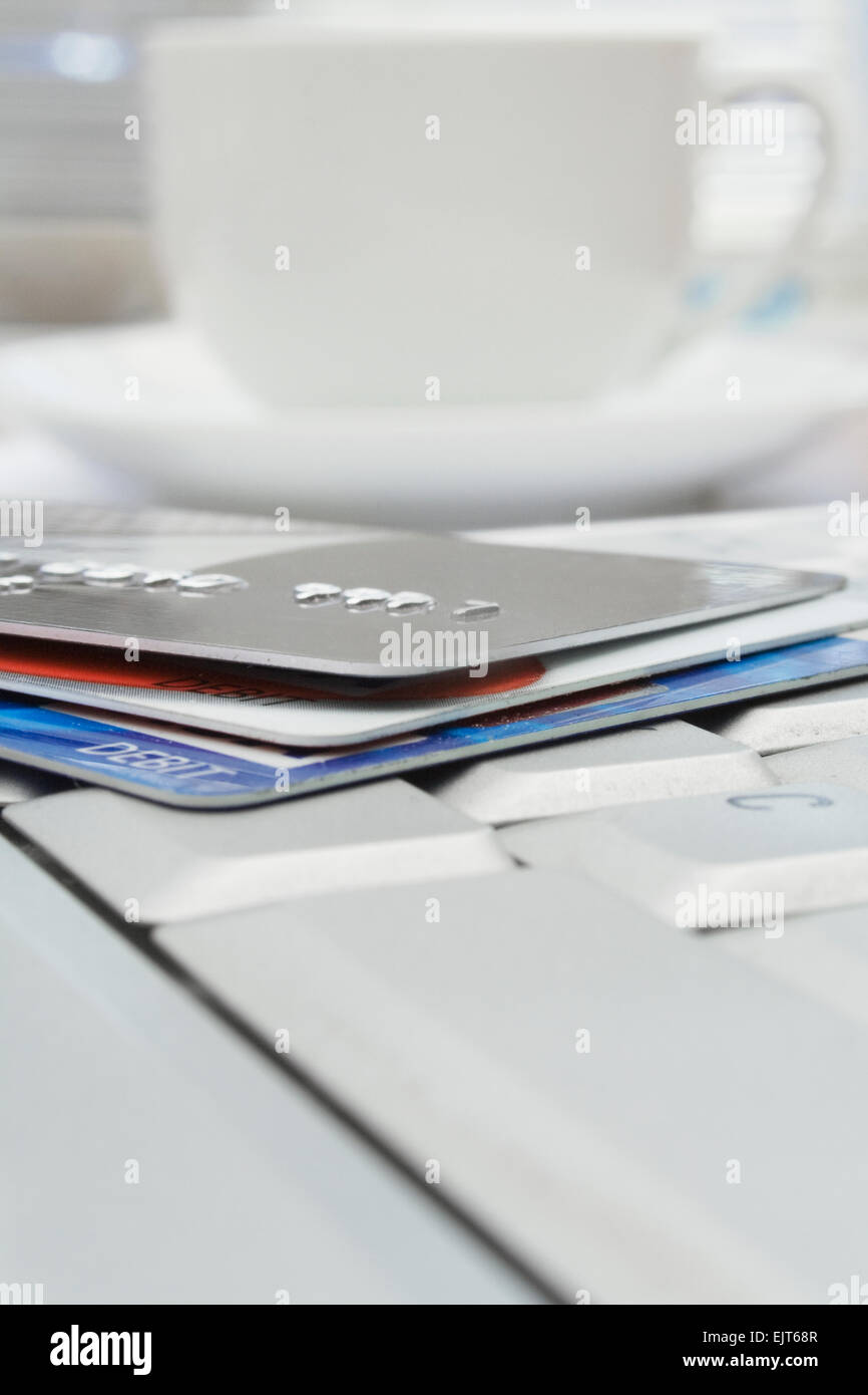 Close up bank and credit cards on a computer laptop with a cup of hot ...