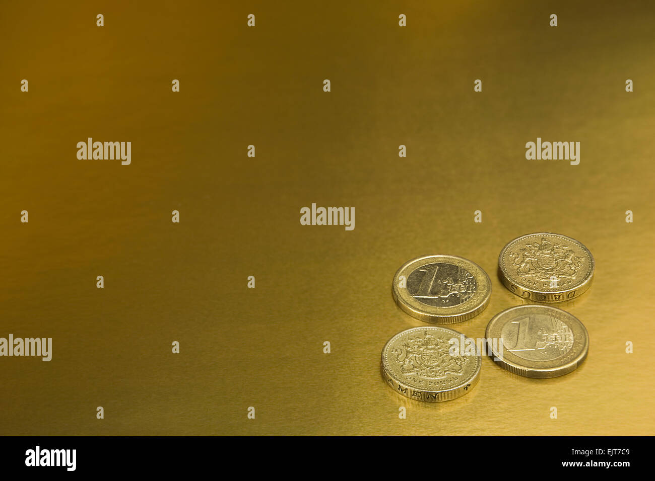 British One Pound And One Euro Coins on a Gold Background Stock Photo ...