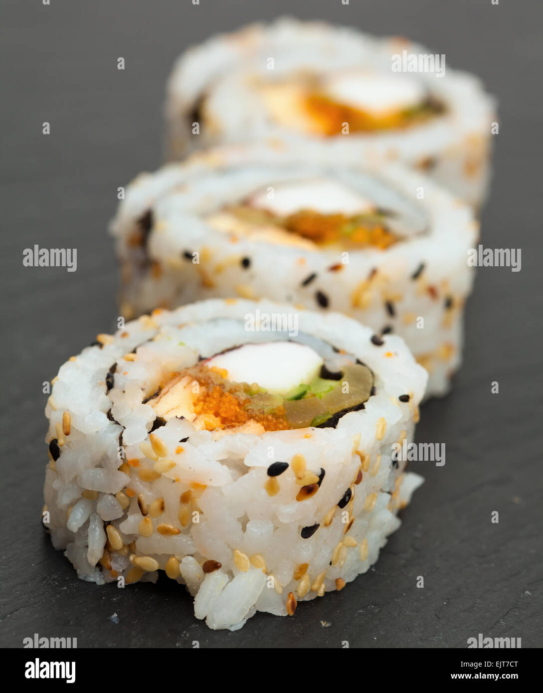 futomaki sushi rolls on a black slate trivet Stock Photo - Alamy
