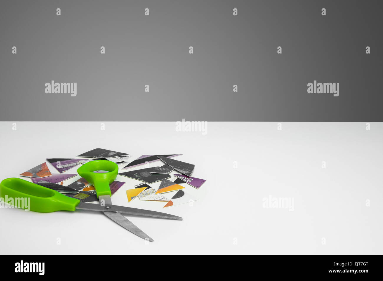 a pair of scissors and a Selection of Credit Cards cut into little ...