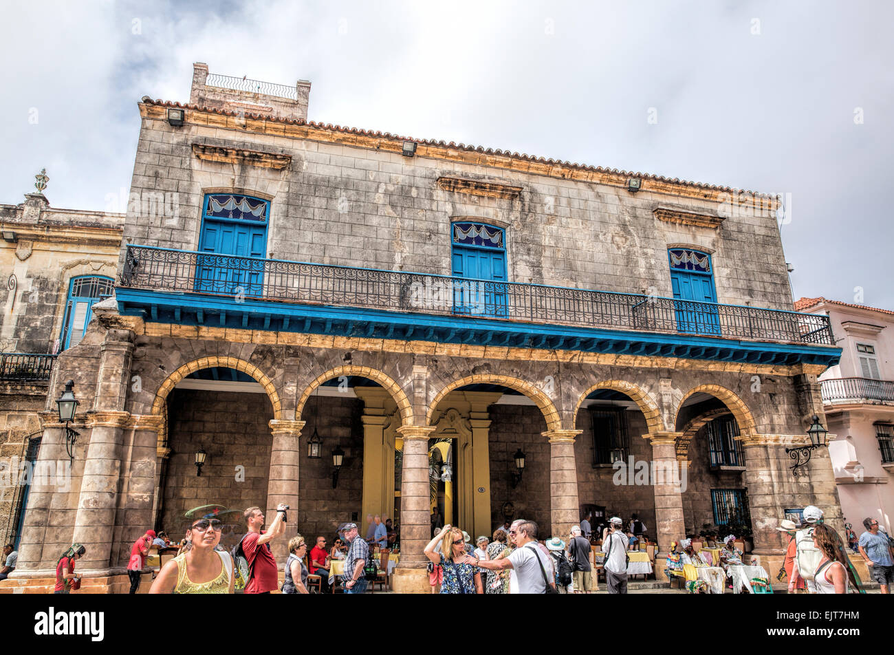 Building in Old Havana with Spanish colonial style arches and blue ...
