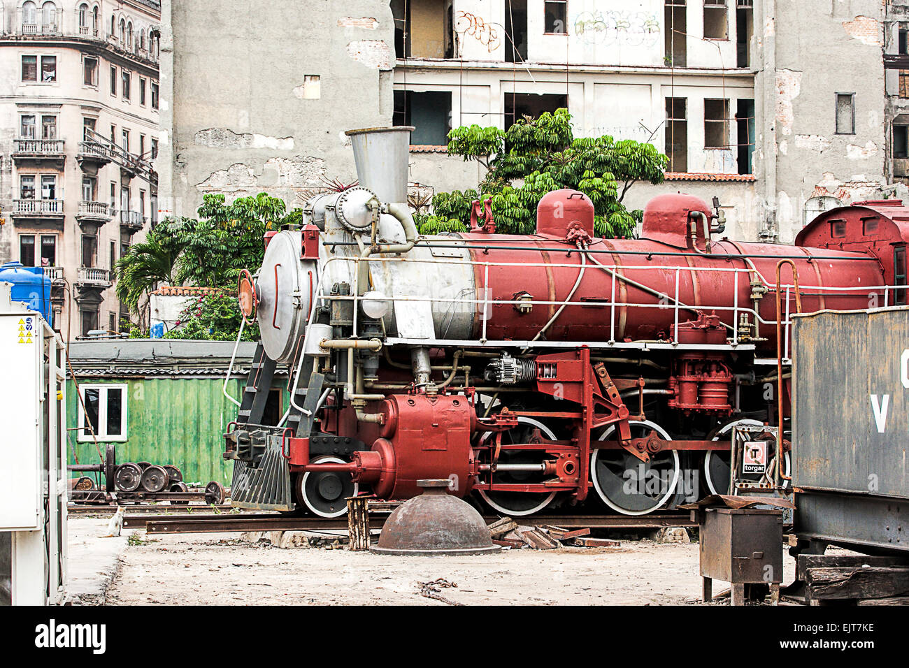 Copper coloured steam engine being repaired in a railway yard in Old ...