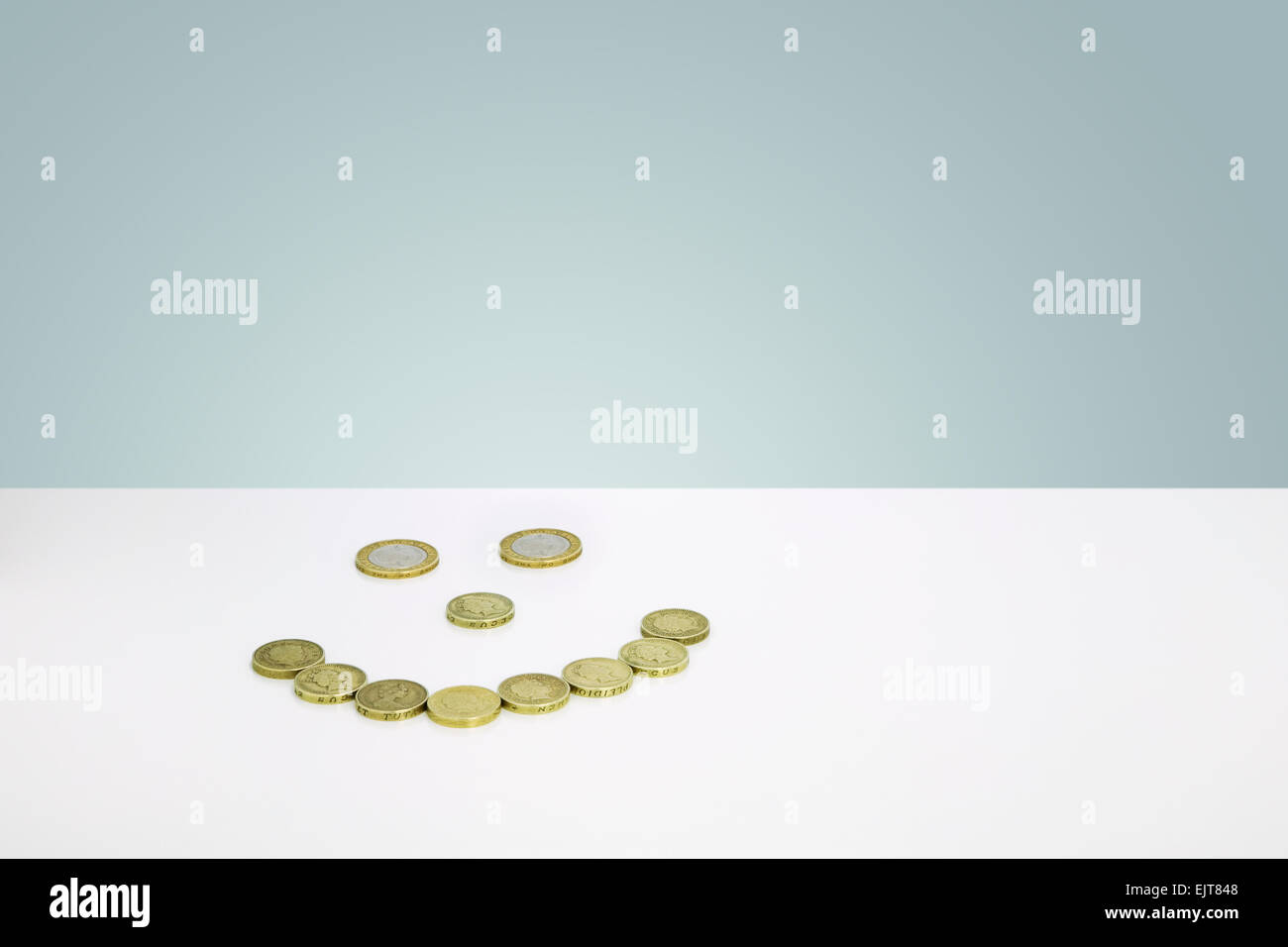 smiley face made out of one pound coins Stock Photo - Alamy
