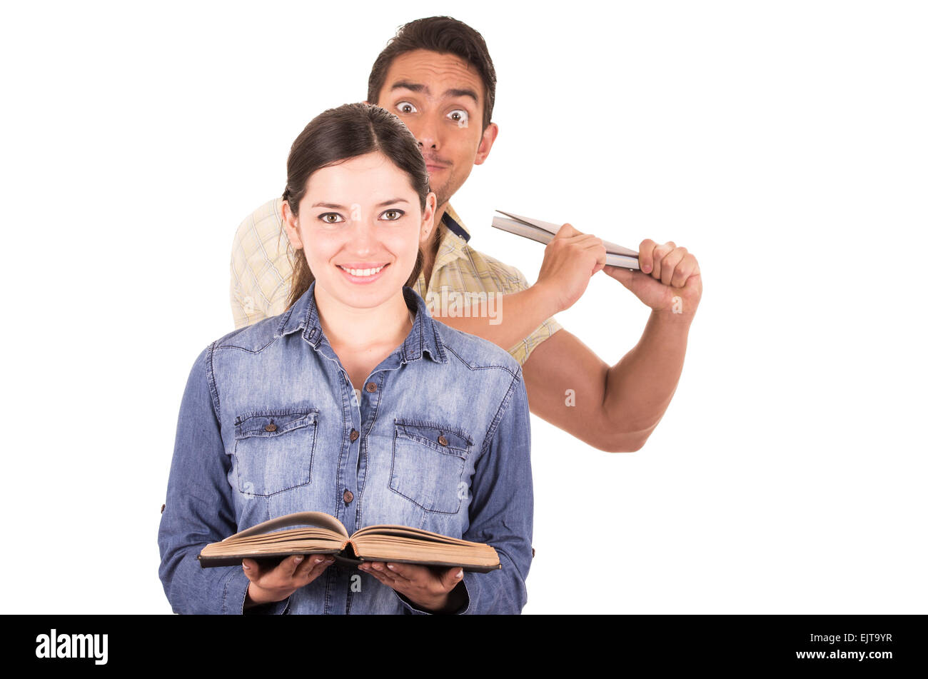 angry young man ready to throw book from behind towards naive sweet ...