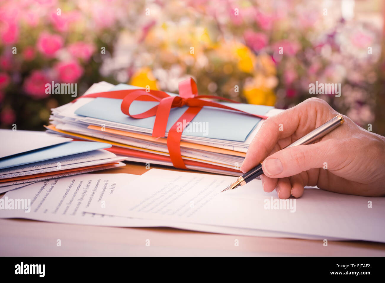 Vintage or retro style Hand with pen writing a letter by pink and ...