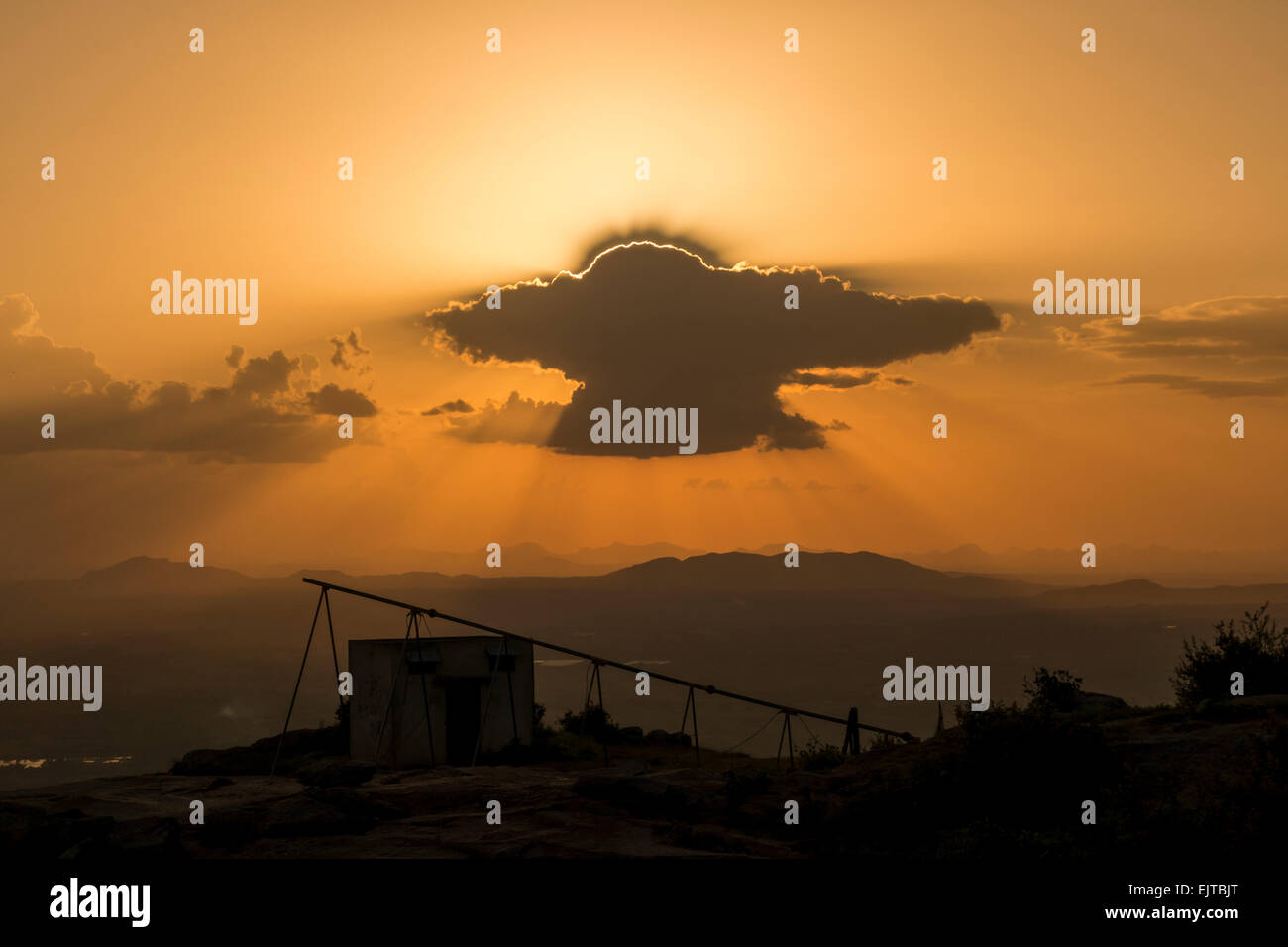 Evening sun rays blocked by a cloud Stock Photo - Alamy