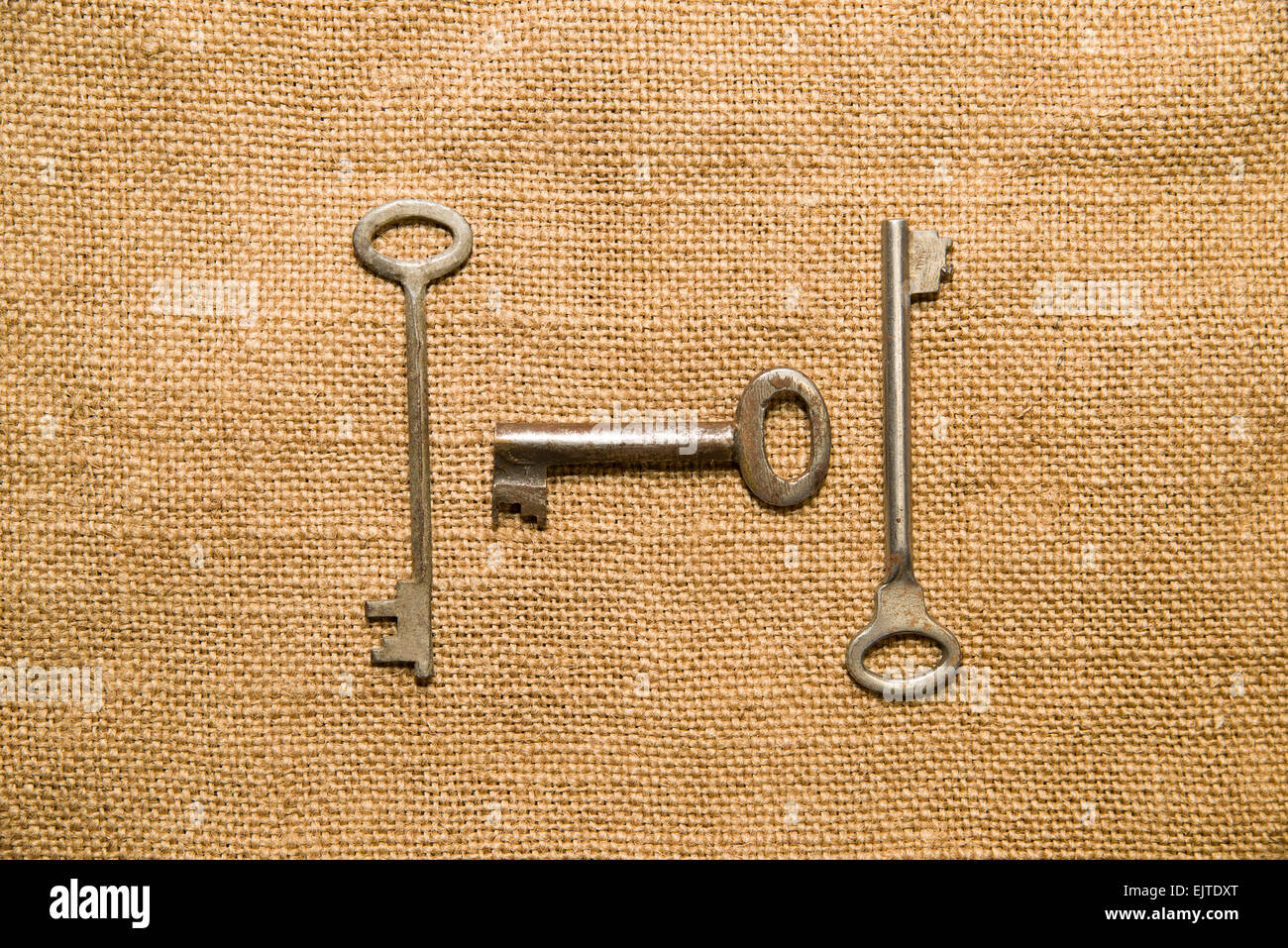 Three vintage keys to the safe on old cloth Stock Photo - Alamy