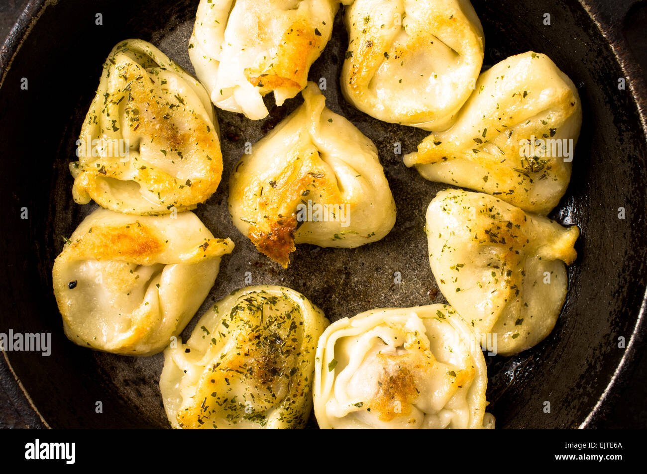 Fried ravioli with meat in a frying pan. Top view close-up Stock Photo ...