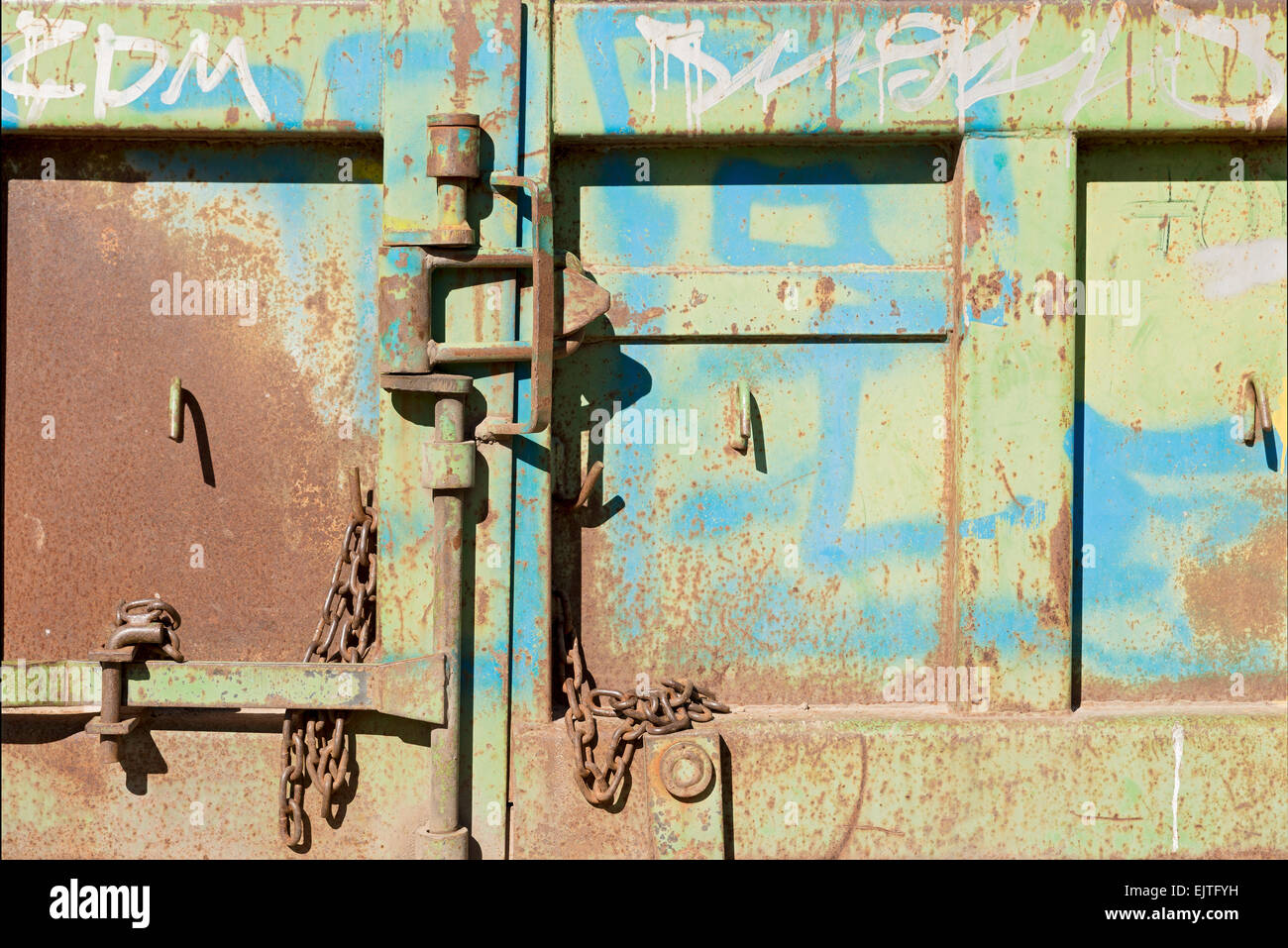 Rusty, corroded old metal door with latch, chain and bolts Stock Photo ...