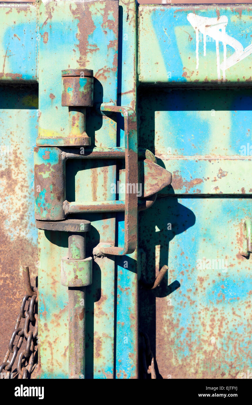 Rusty, corroded old metal door with latch, chain and bolts Stock Photo ...