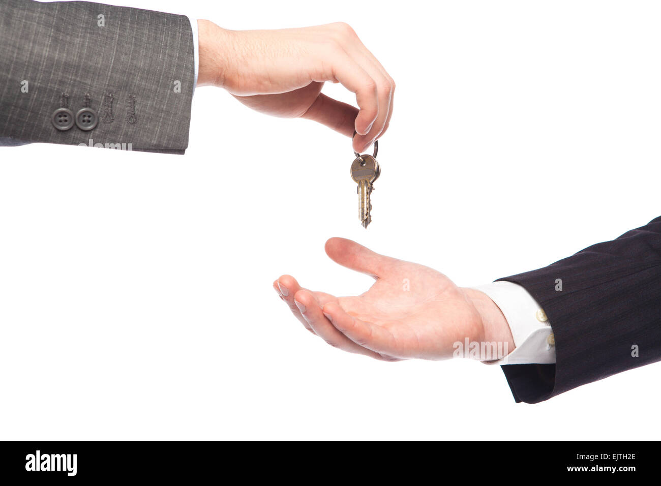 Hands of two businessman, giving and taking modern key, isolated over ...