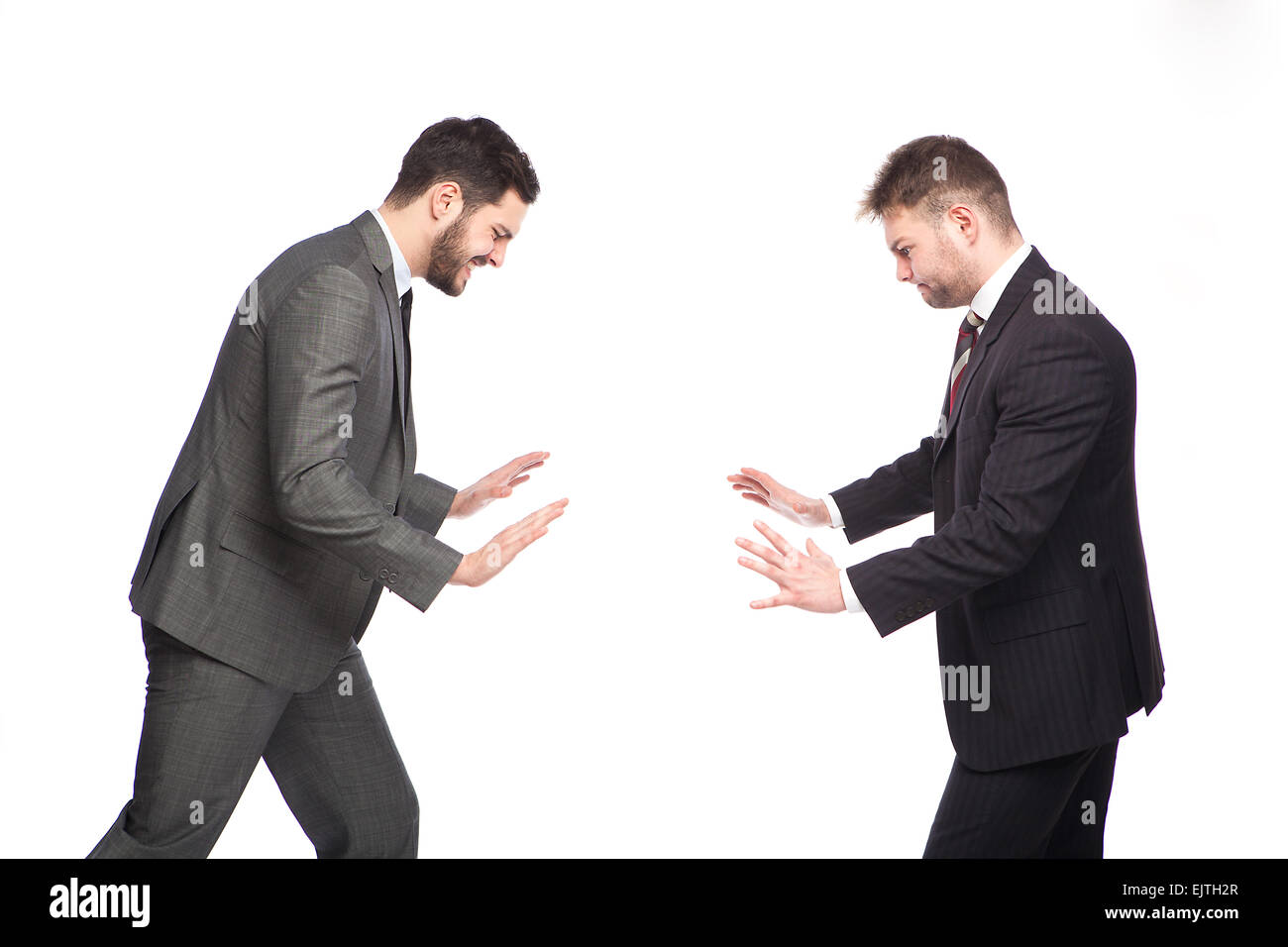 business people pushing something very hard on white background Stock ...