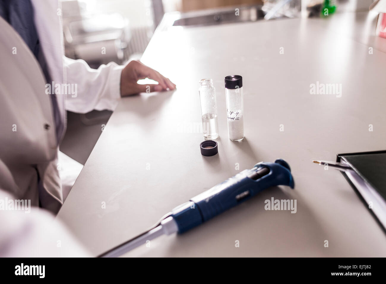 Doctor with medicine and pipette at desk in hospital Stock Photo - Alamy