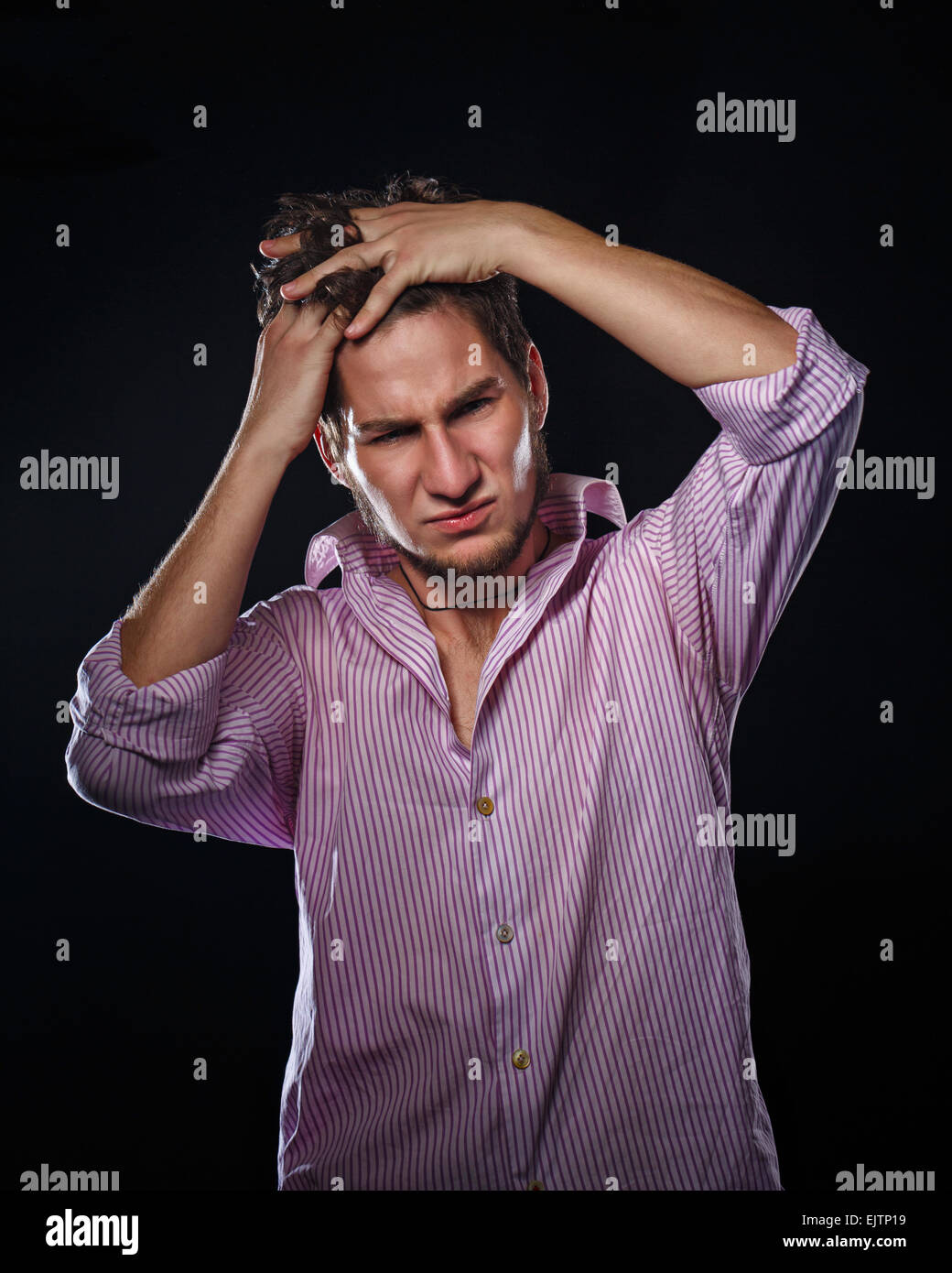 Handsome and stylish. Handsome bearded young man touching his hair and ...