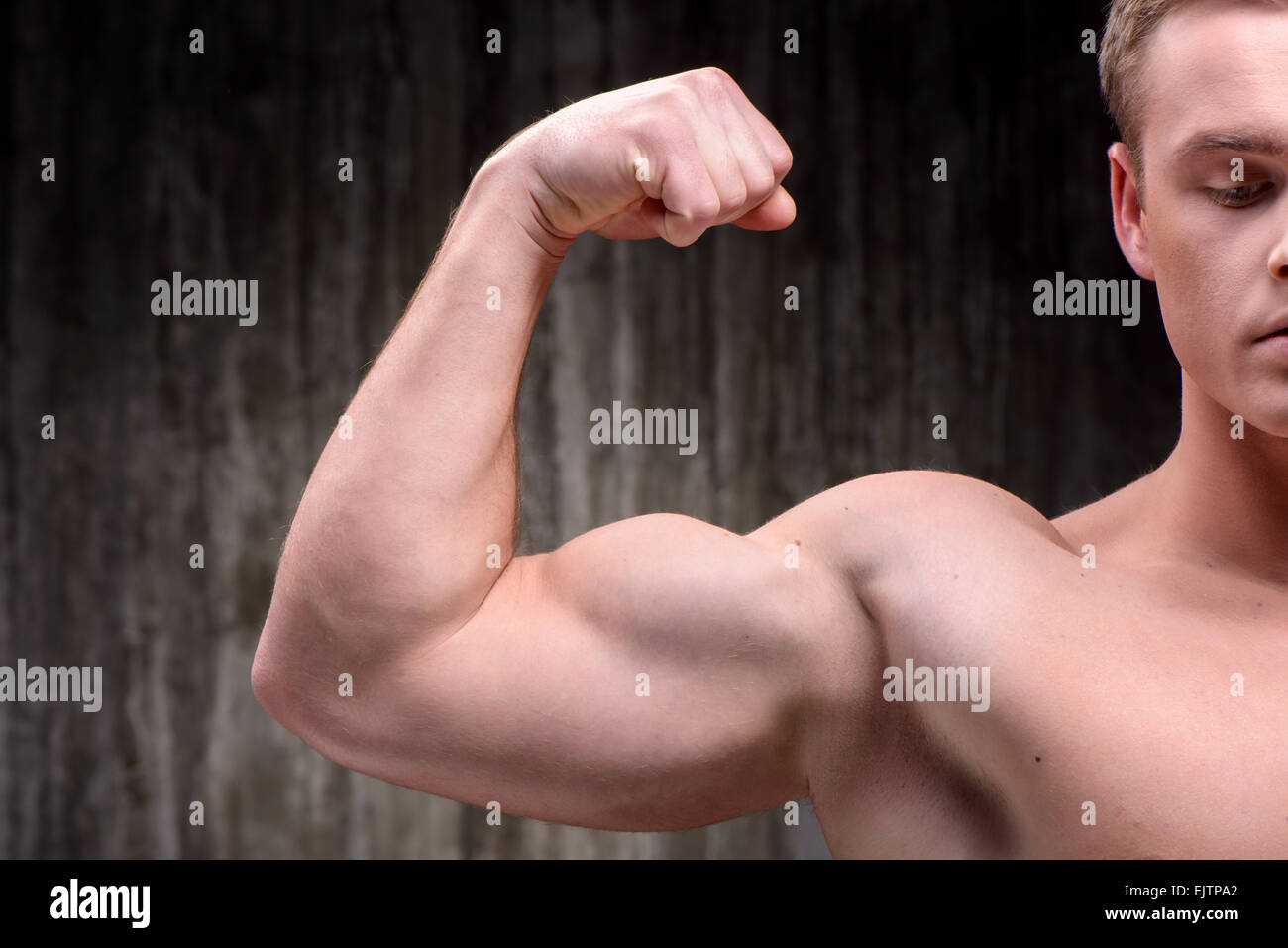 Close up of well formed man demonstrating biceps Stock Photo - Alamy