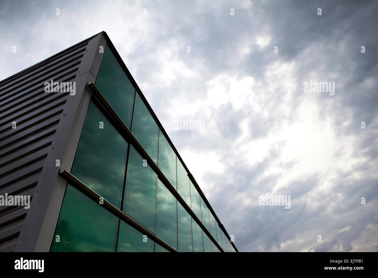 Close up of a modern building and cloudy sky Stock Photo - Alamy