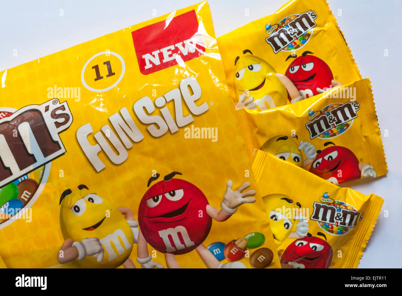 New pack of 11 fun size packet of peanut M&M's set on white background ...