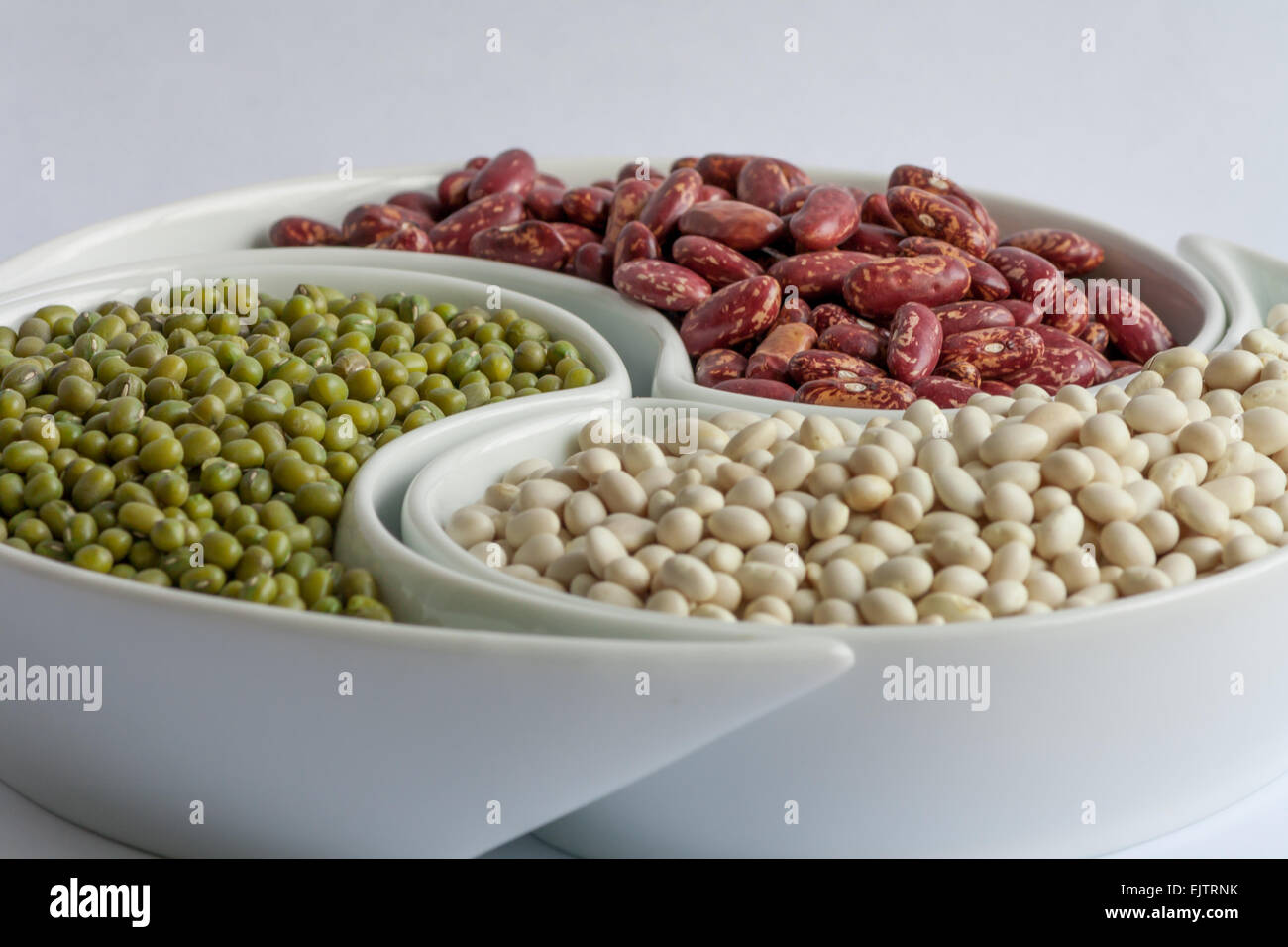Different types of Multicolored beans in white ceramics bowl Stock ...