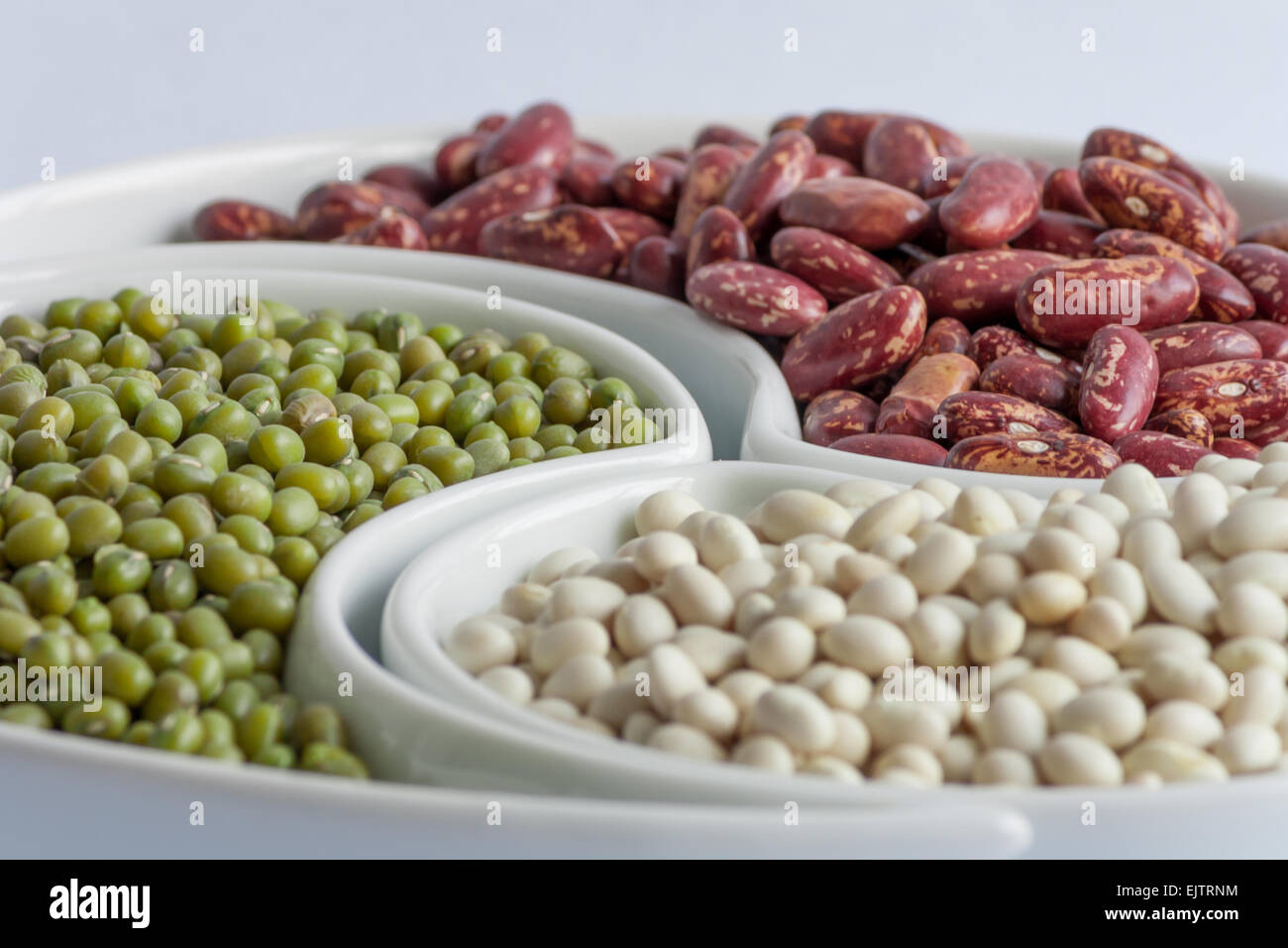Different types of Multicolored beans in white ceramics bowl Stock ...