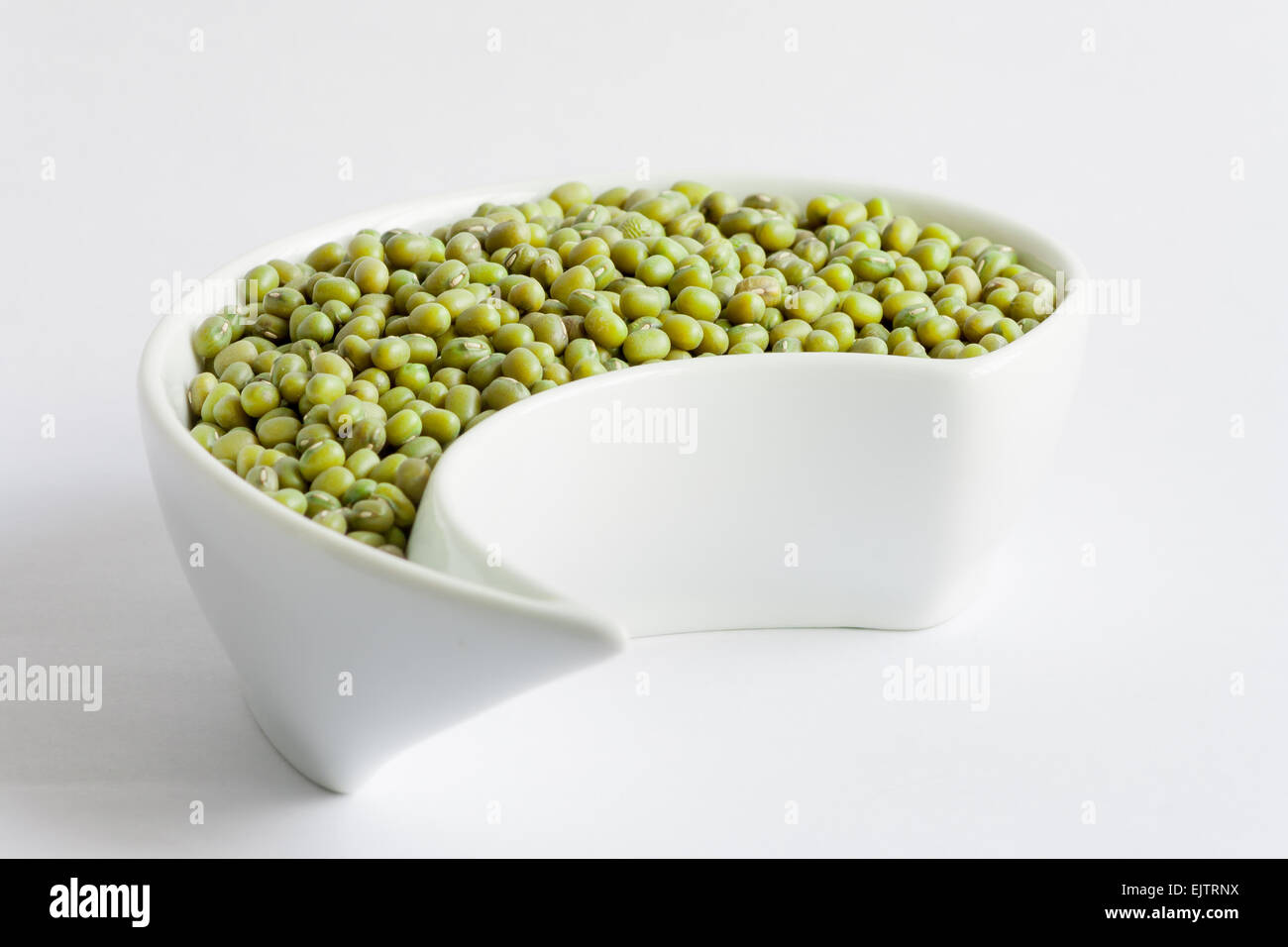 Green small beans in white ceramics bowl on white background Stock ...