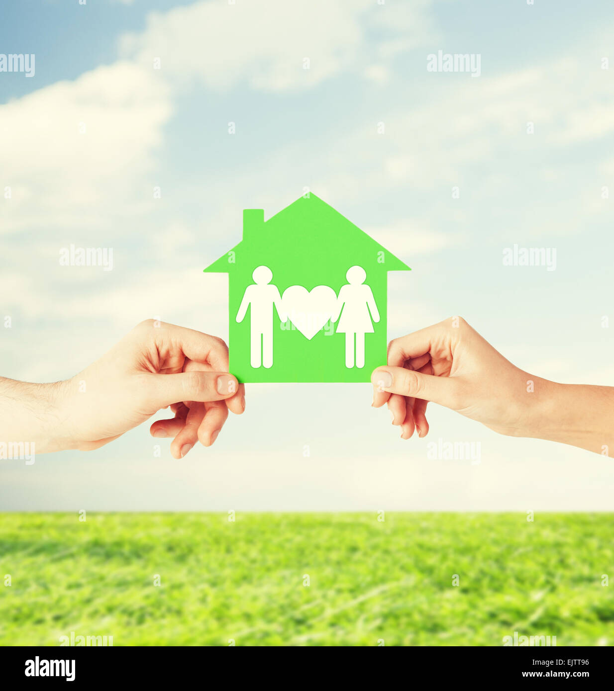 hands holding green house with family Stock Photo - Alamy