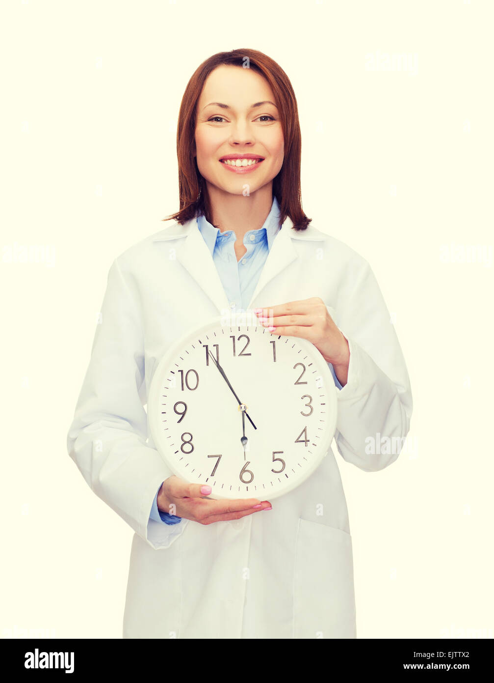 smiling female doctor with wall clock Stock Photo - Alamy