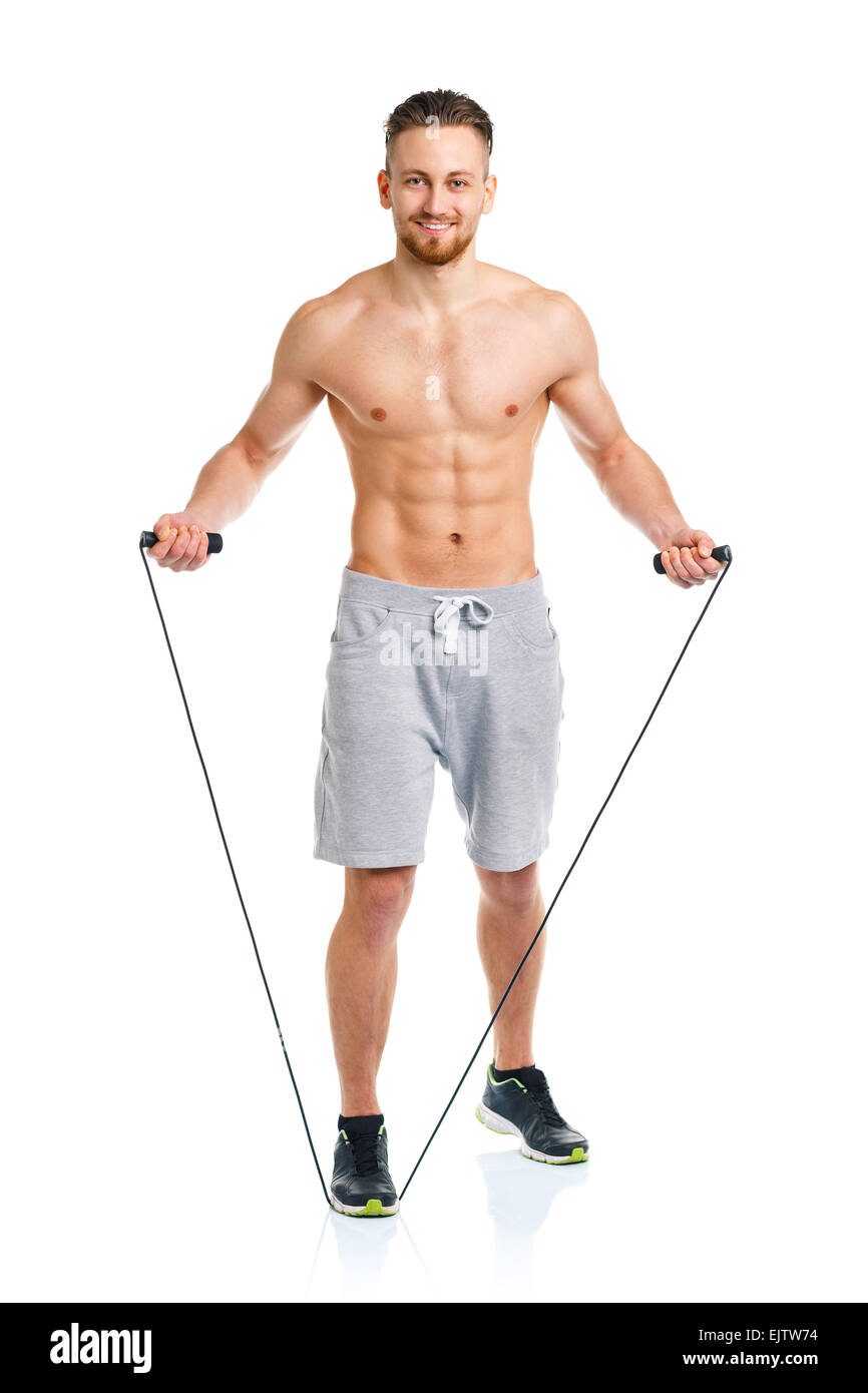 Athletic attractive man jumping on a rope on the white background Stock ...