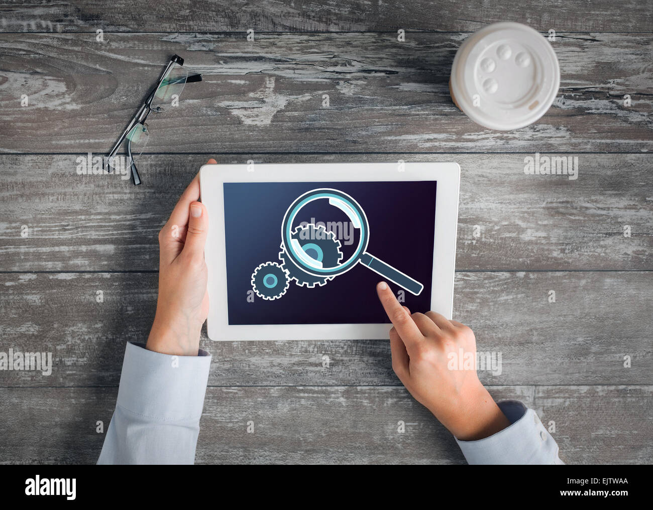 close up of hands with tablet pc and settings Stock Photo - Alamy