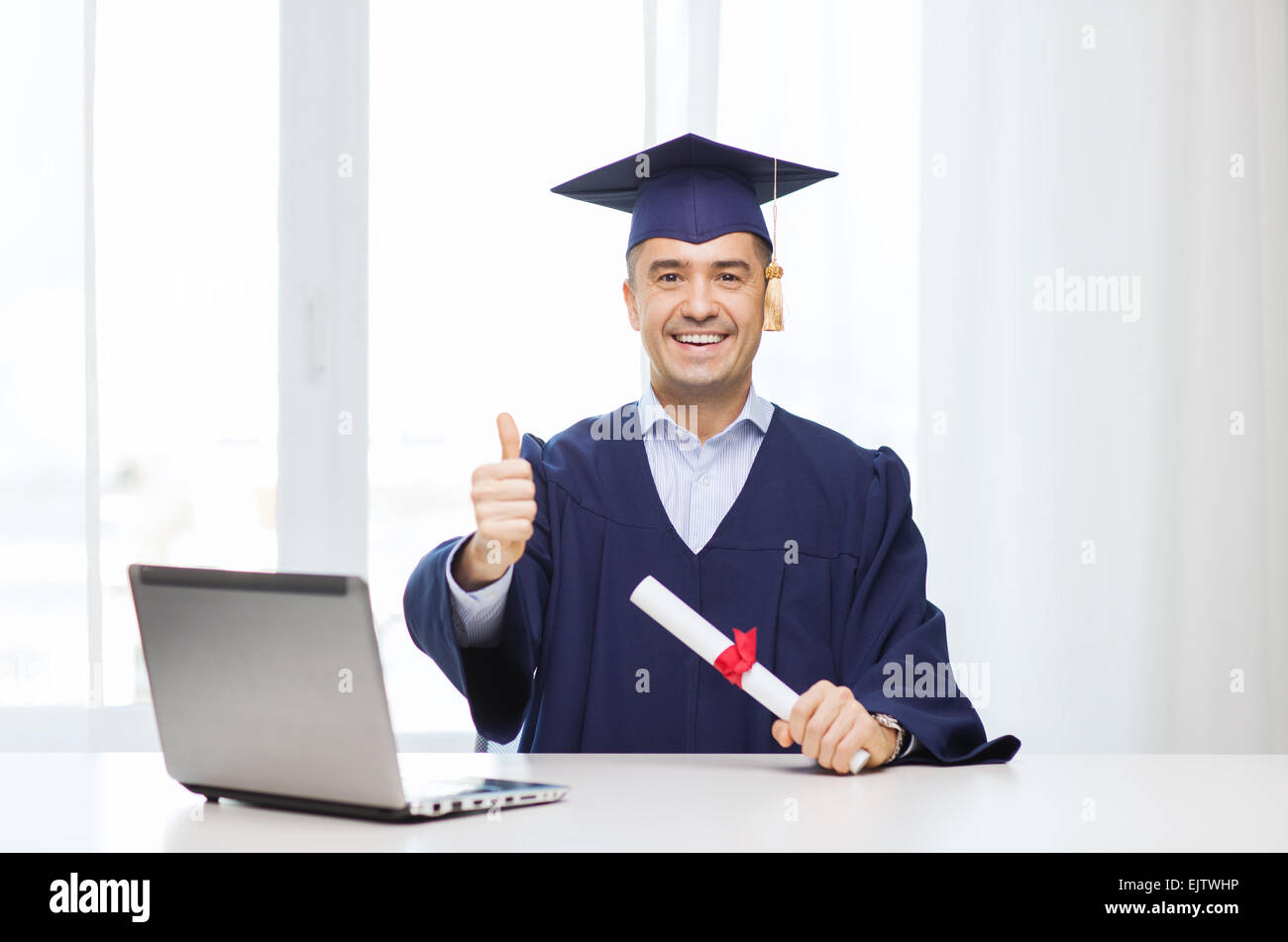 smiling adult student in mortarboard with diploma Stock Photo - Alamy