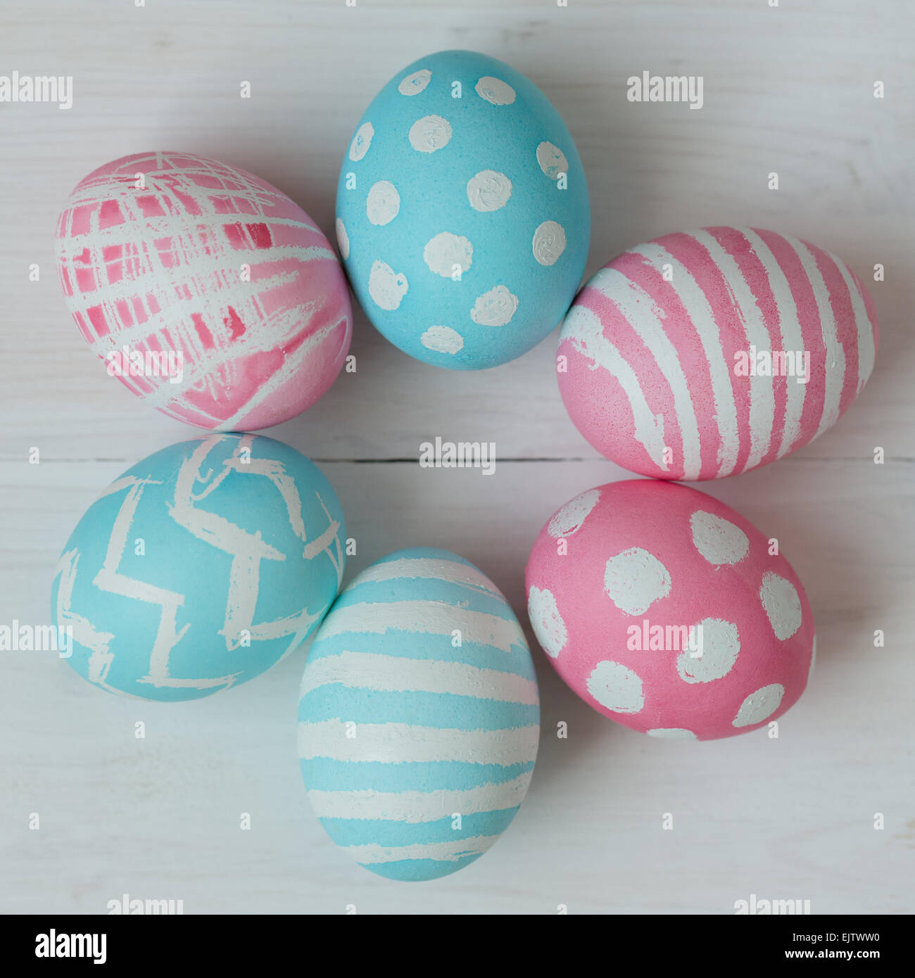 Pink and blue easter eggs on a wooden background Stock Photo - Alamy