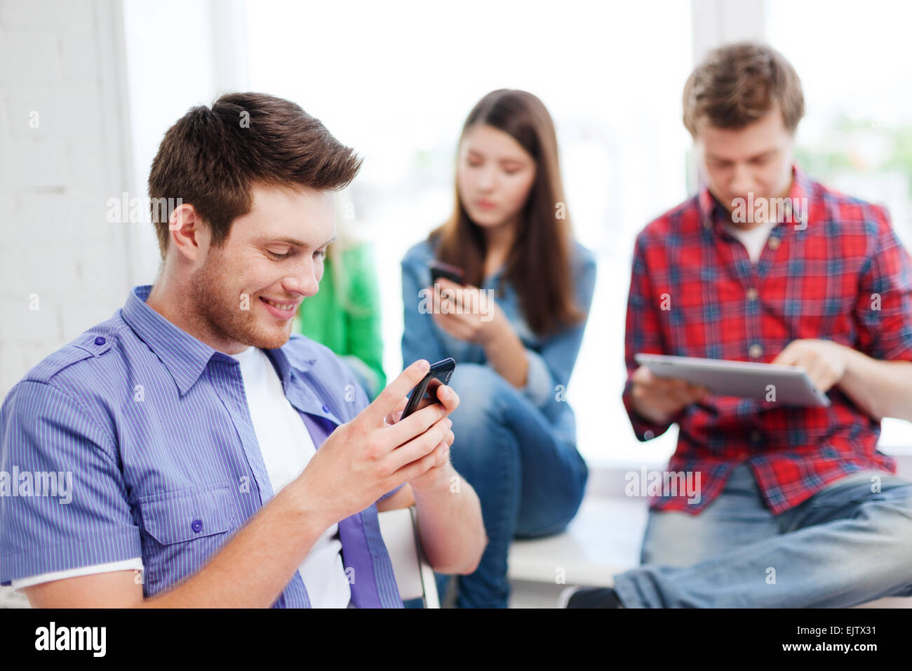 student looking into smartphone at school Stock Photo - Alamy