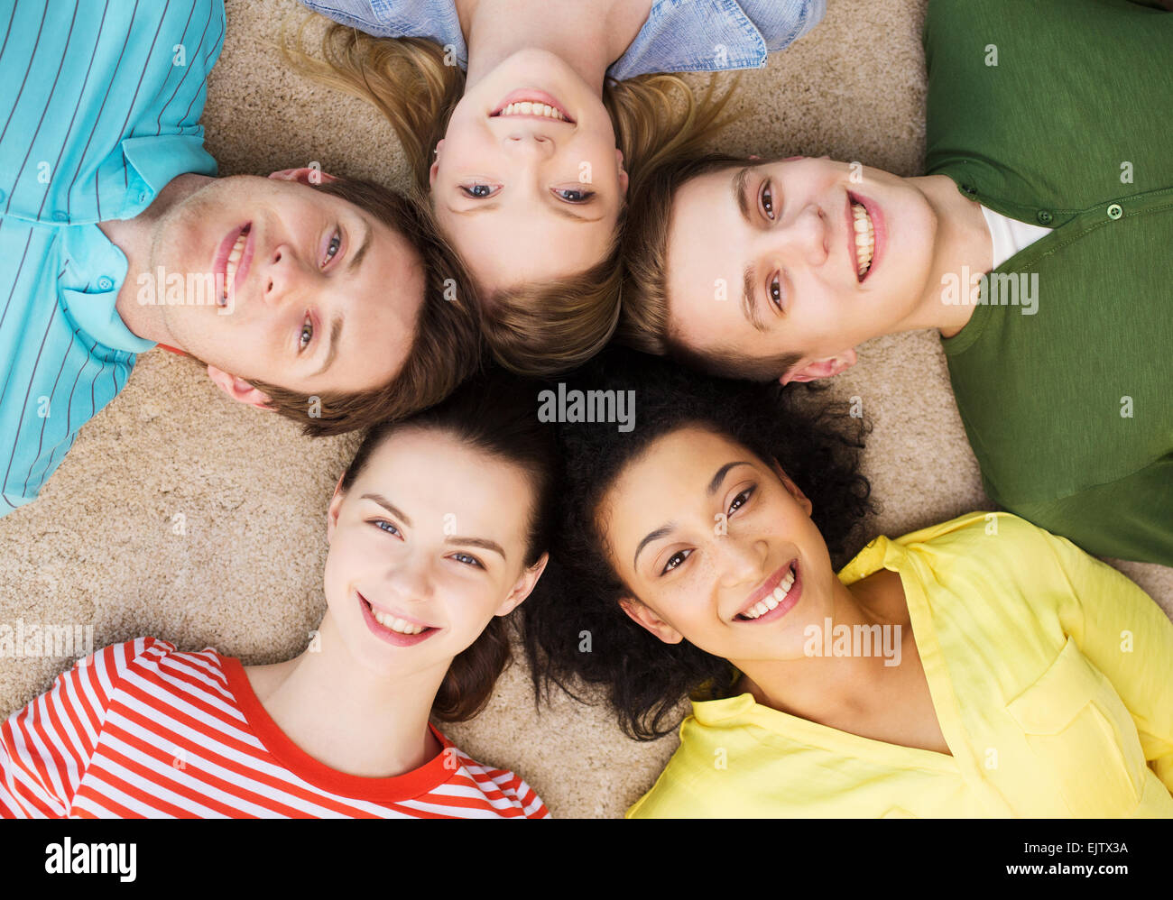 group of smiling people lying down on floor Stock Photo - Alamy
