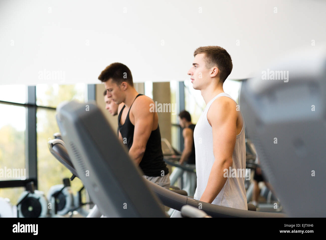group of men exercising on treadmill in gym Stock Photo - Alamy