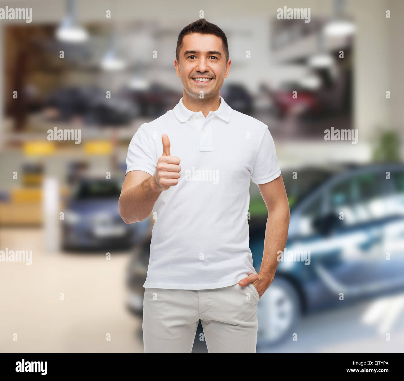 man showing thumbs up over auto show background Stock Photo - Alamy