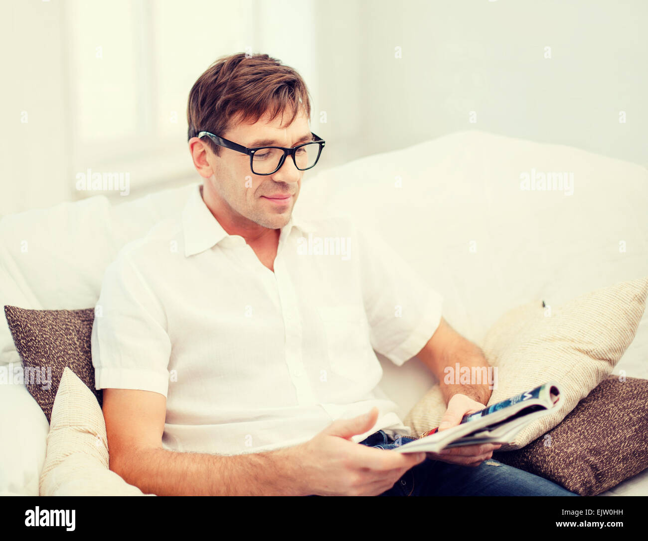 man with magazine at home Stock Photo - Alamy