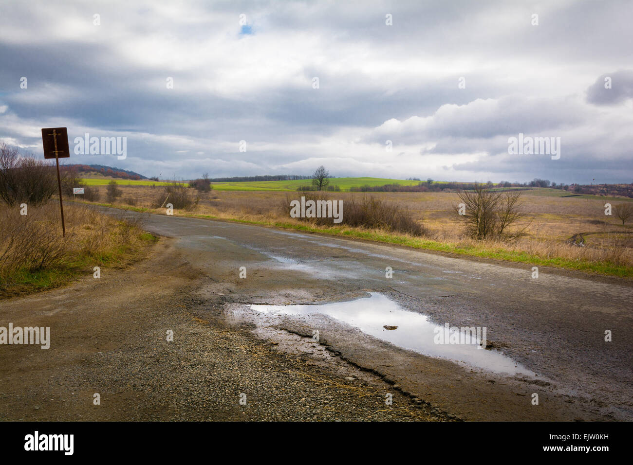 Muddy street in a village with puddle Stock Photo - Alamy