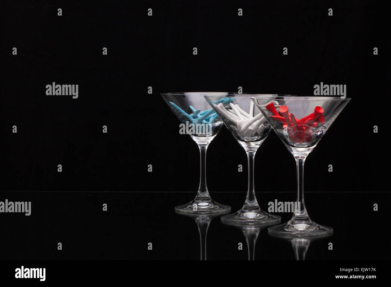 Three glasses of champagne with golf tees Stock Photo - Alamy