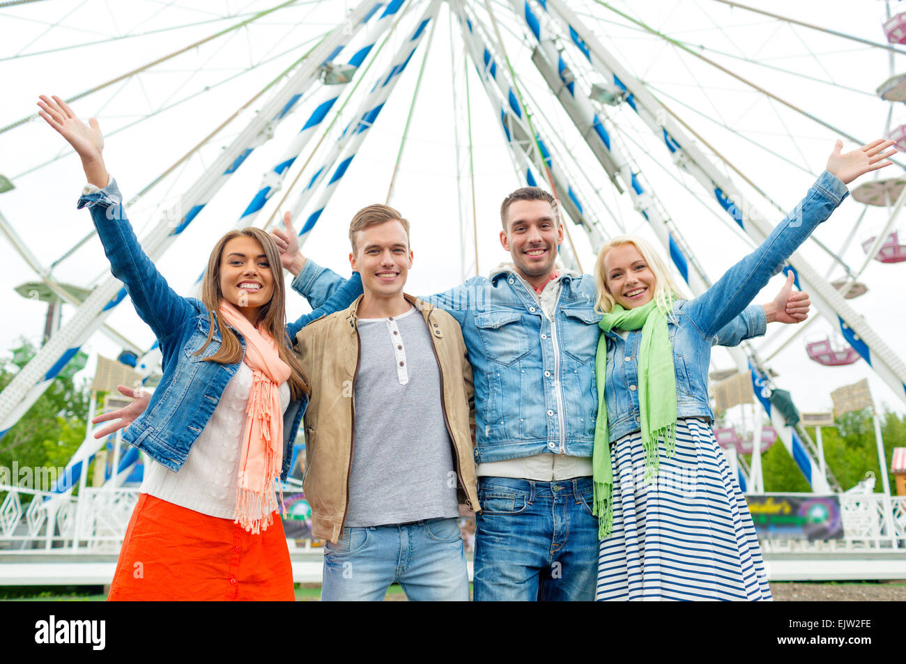 group of smiling friends waving hands Stock Photo - Alamy