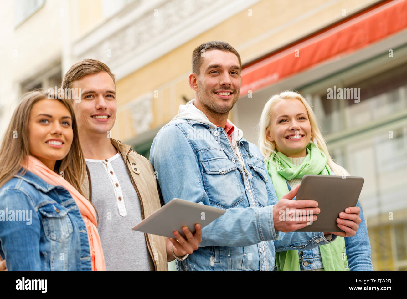 group of smiling friends with tablet pc computers Stock Photo - Alamy