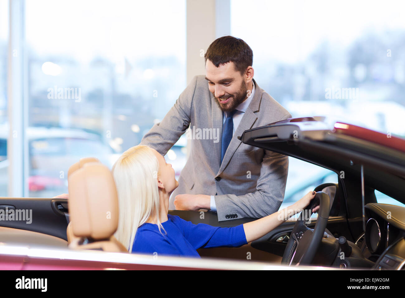 happy couple buying car in auto show or salon Stock Photo - Alamy
